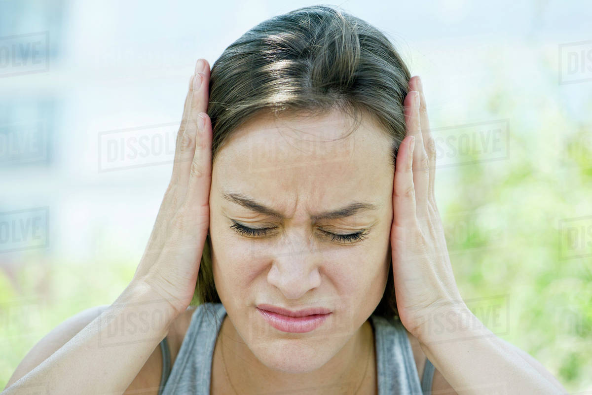Distressed woman with head in hands - Royalty-free Stock Photo | Dissolve