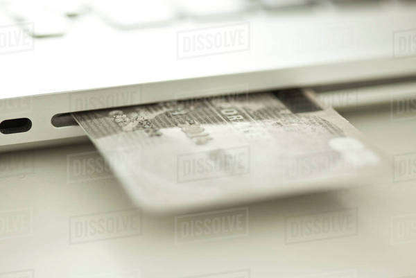 Credit card sticking out of side of laptop computer - Stock Photo ...