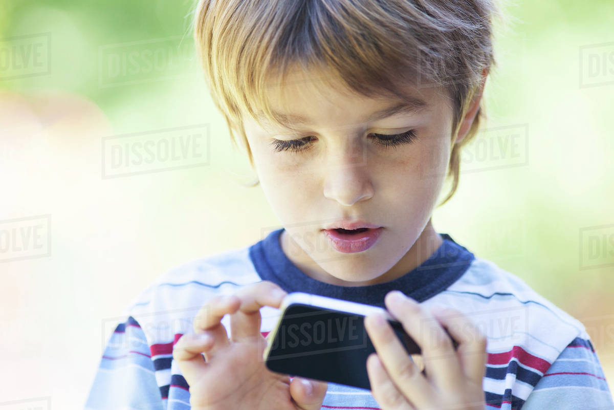 Boy using smartphone - Royalty-free Stock Photo | Dissolve