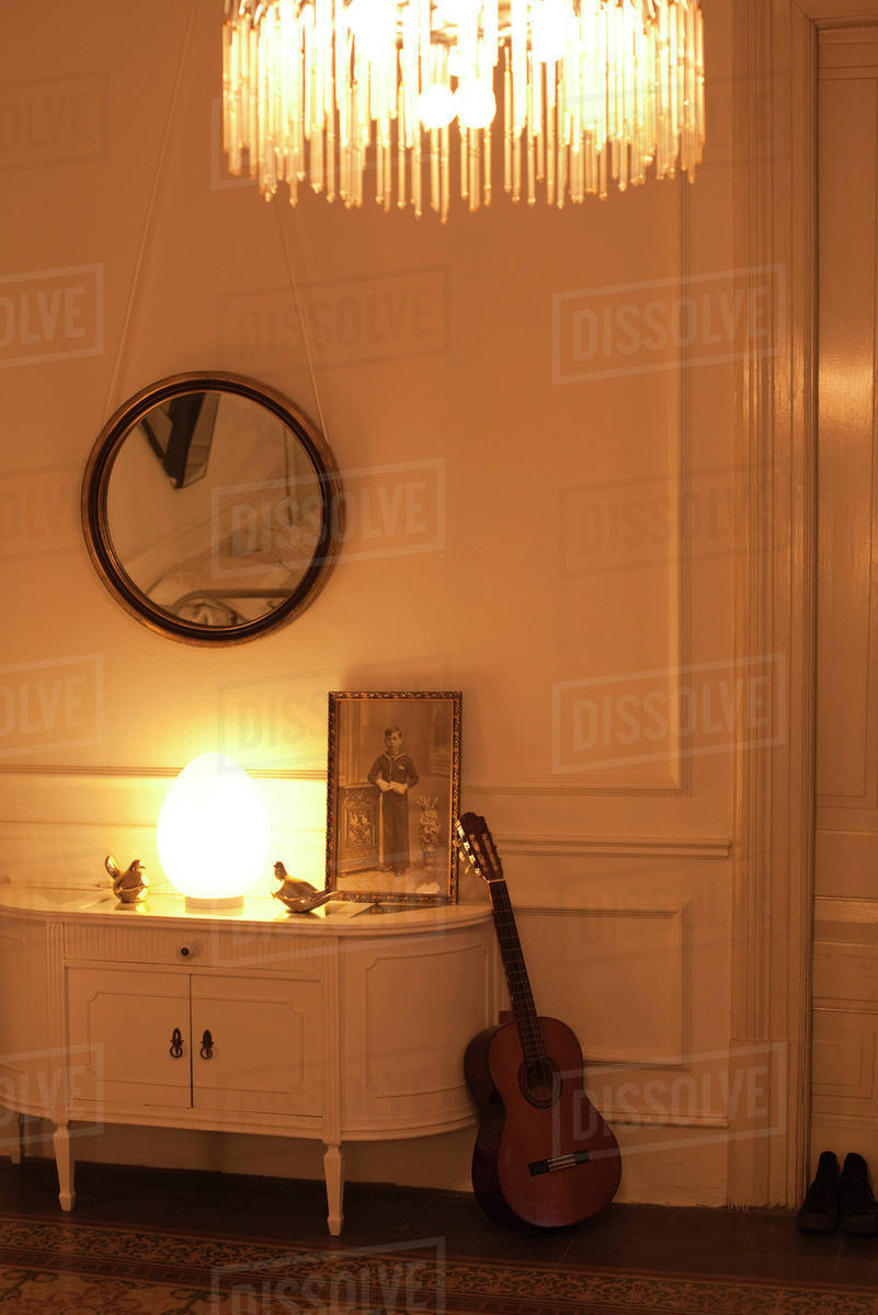 Home interior lit by lamp and chandelier - Stock Photo - Dissolve