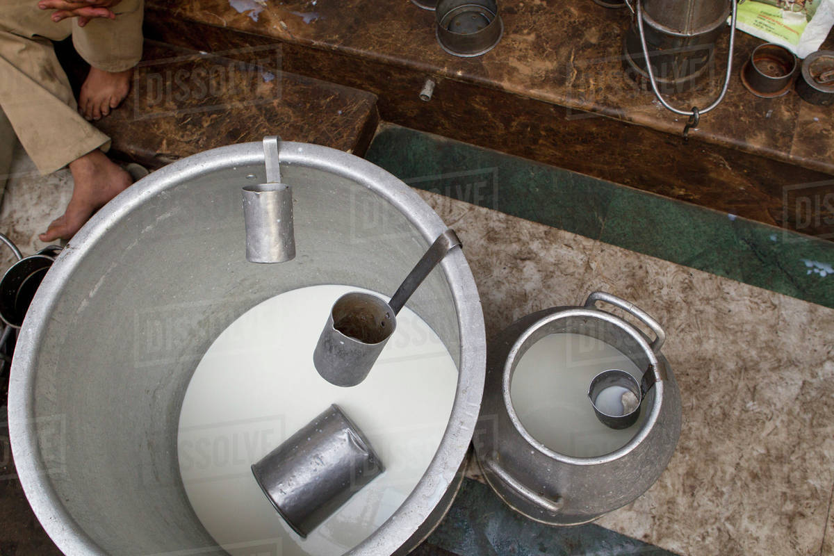 Milk in bucket with ladles, overhead view - Royalty-free Stock Photo ...