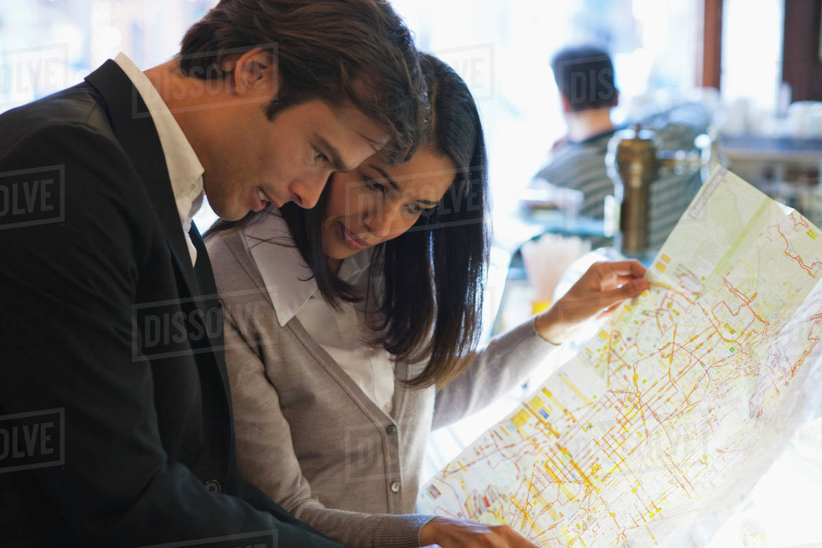Couple looking at map together - Royalty-free Stock Photo | Dissolve