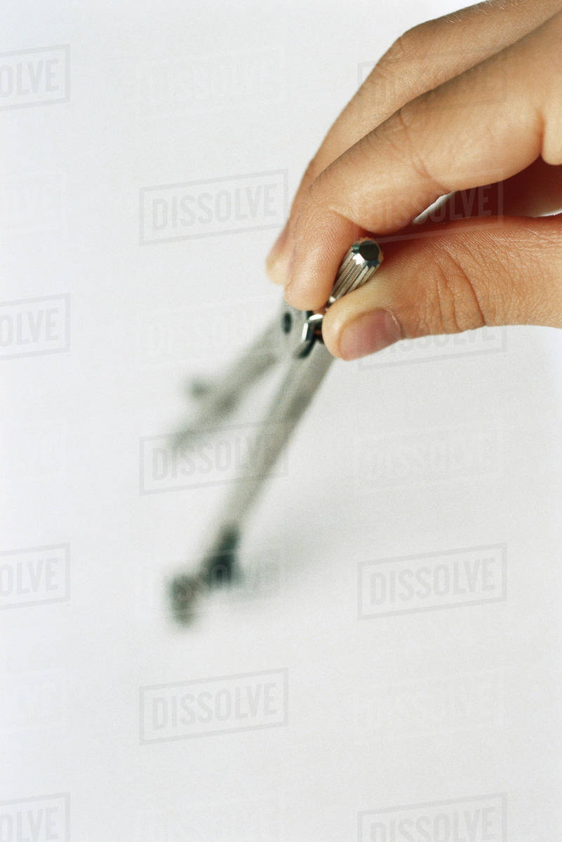 Hand holding drawing compass - Royalty-free Stock Photo | Dissolve