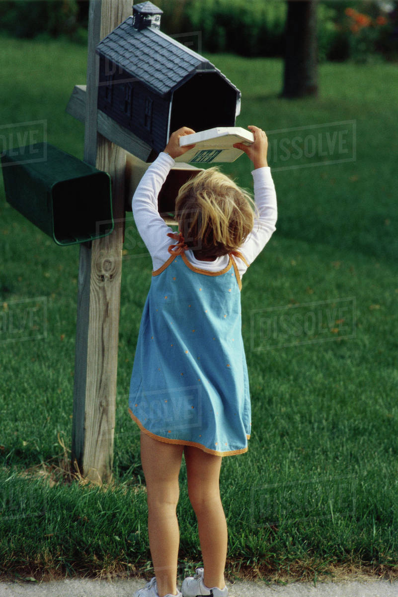 Little girl checking mailbox - Royalty-free Stock Photo | Dissolve