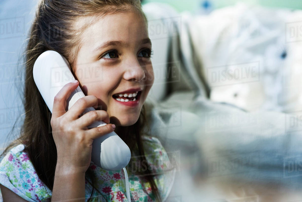 Little girl smiling using landline phone - Royalty-free Stock Photo ...