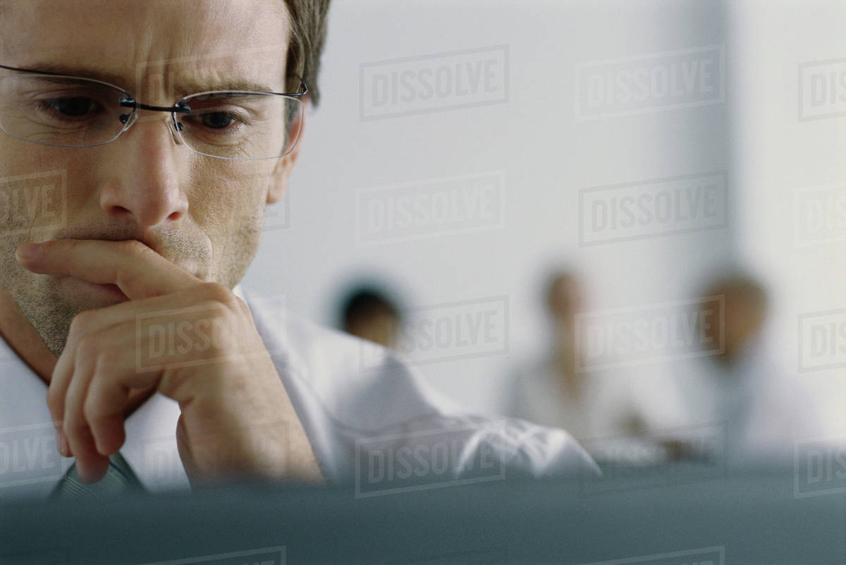 Businessman looking at computer screen with concern - Stock Photo ...