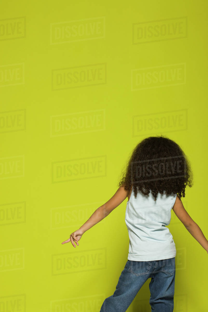 Little girl dancing, rear view - Royalty-free Stock Photo | Dissolve