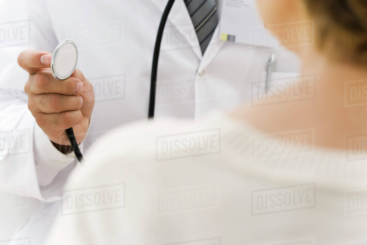 Doctor preparing to examine patient using stethoscope - Royalty-free ...