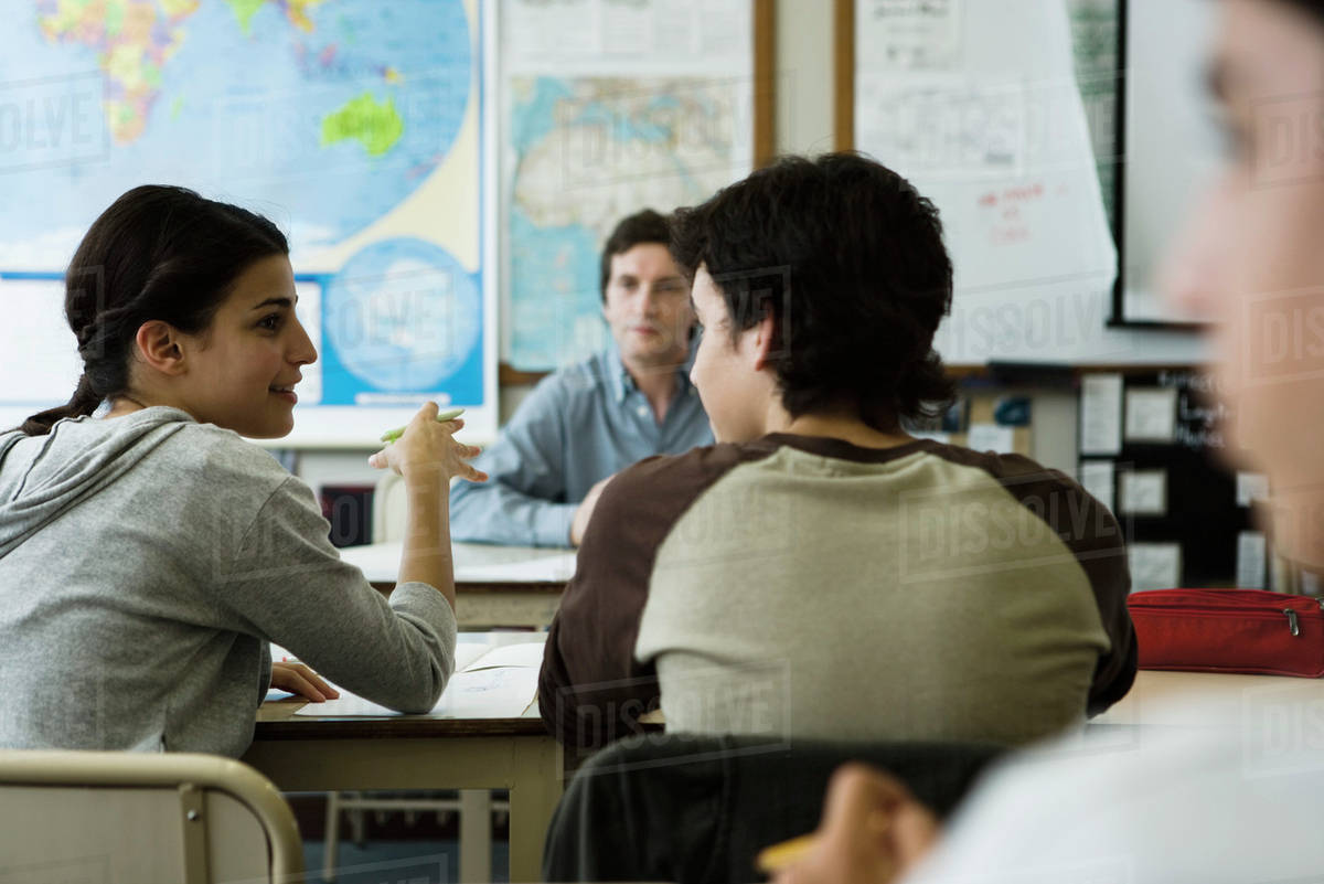 High school student speaking with classmate in class - Stock Photo ...