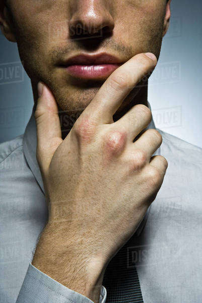 Businessman with hand under chin, portrait - Royalty-free Stock Photo ...