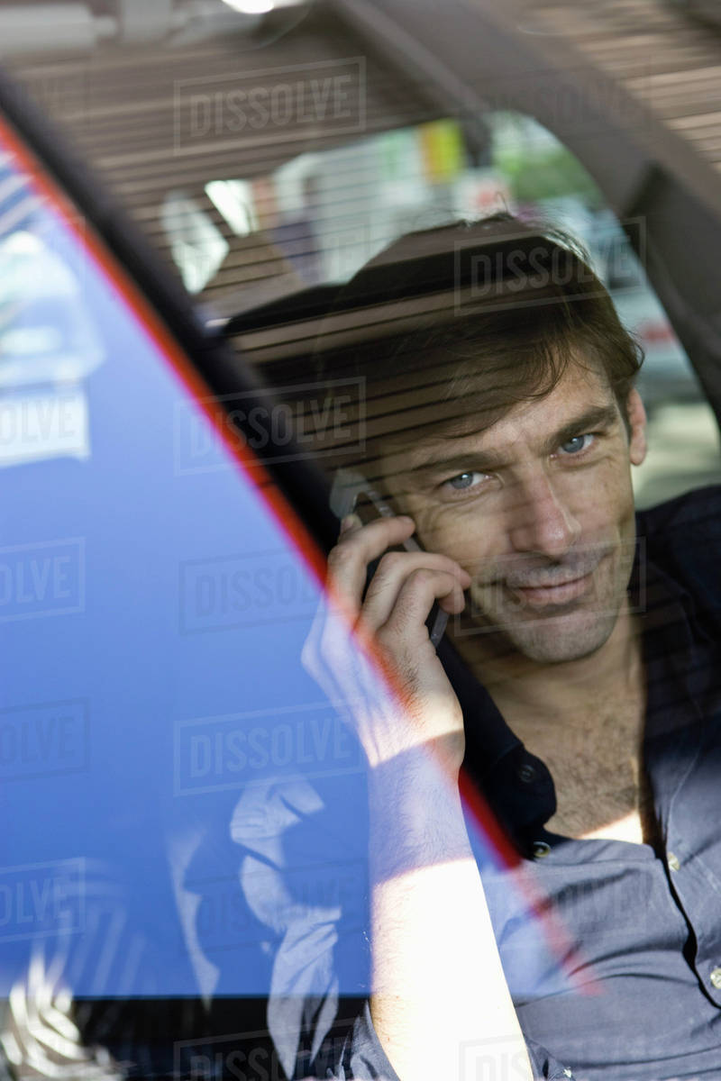 Man using cell phone while driving - Royalty-free Stock Photo | Dissolve