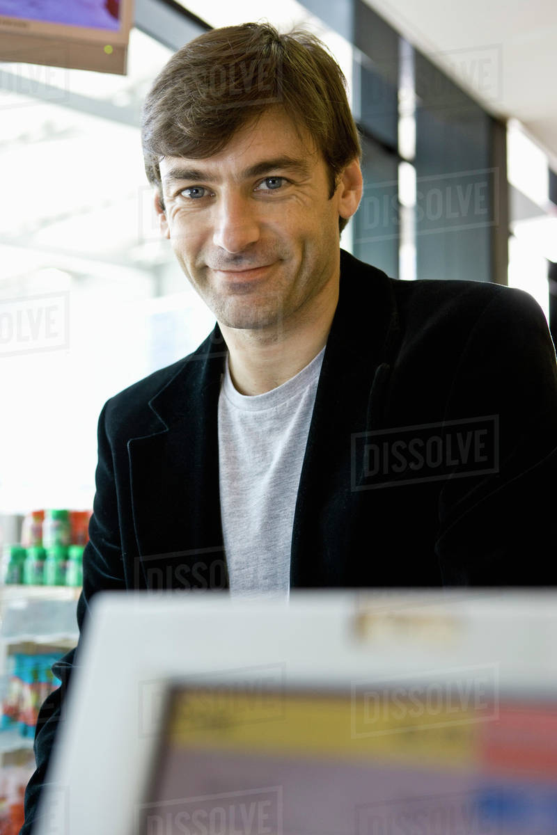 Customer waiting at checkout counter - Stock Photo - Dissolve