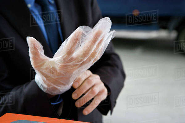 Putting on disposable gloves preparing to refuel vehicle - Stock Photo ...