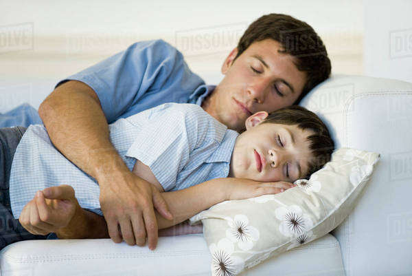 Father and son napping together on sofa - Royalty-free Stock Photo ...