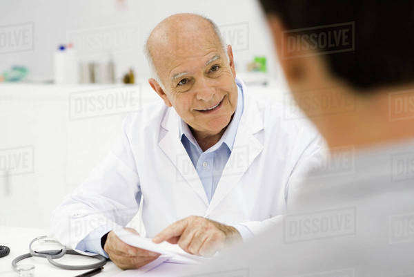 Doctor cheerfully explaining positive test results to patient - Stock ...