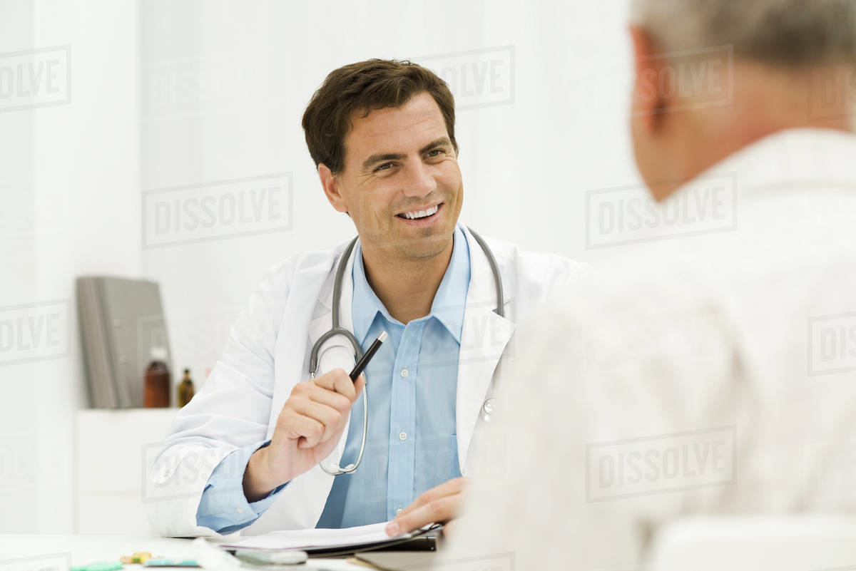 Doctor with senior patient providing medical consultation - Royalty ...