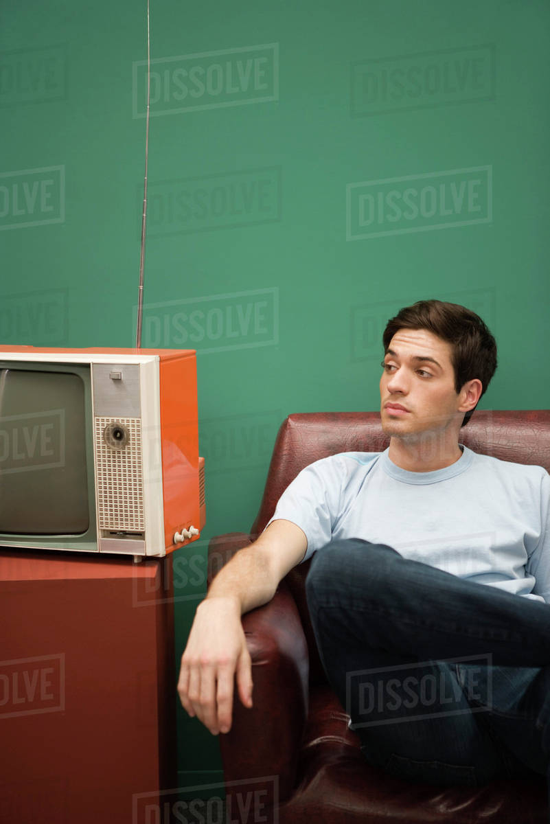 Man sitting in chair, looking away impatiently - Royalty-free Stock ...