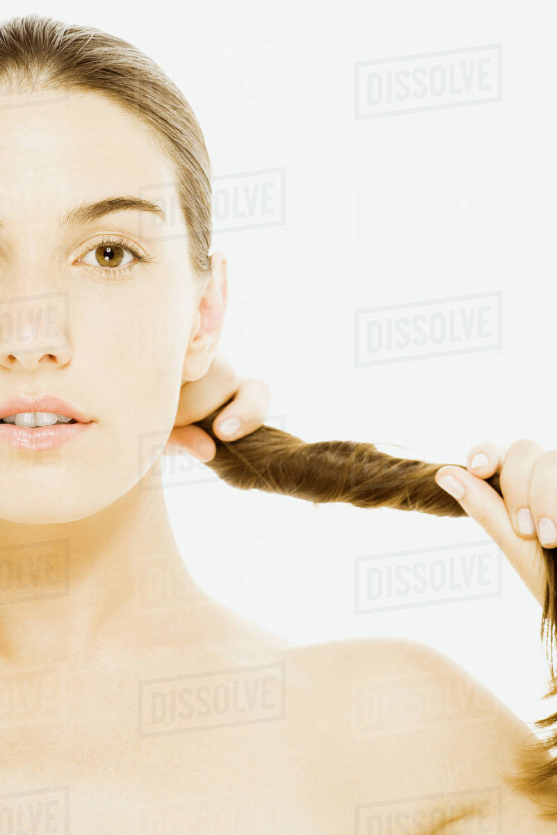 Woman twisting hair - Royalty-free Stock Photo | Dissolve