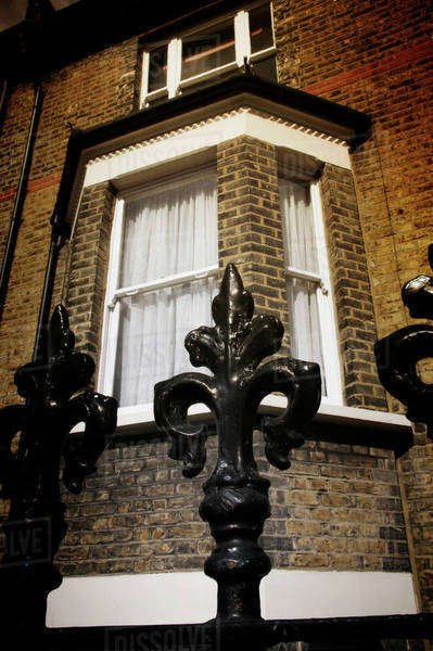 Wrought iron fence and bay window - Stock Photo - Dissolve