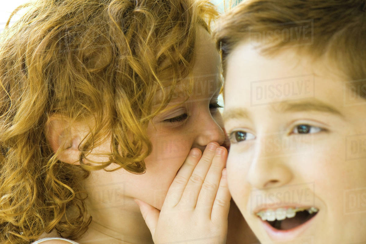 Little girl whispering in her brother's ear, close-up - Royalty-free ...