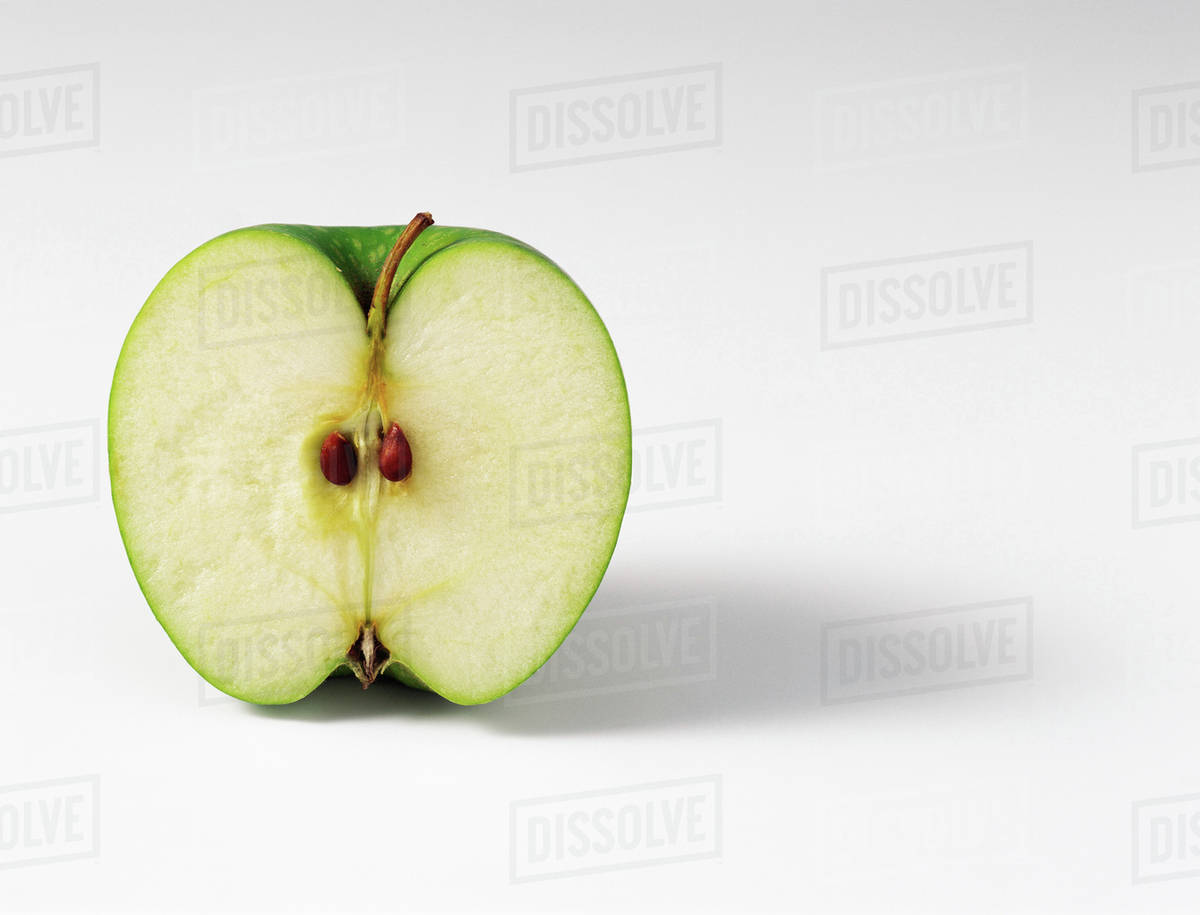 Green apple, cross section, close-up - Royalty-free Stock Photo | Dissolve