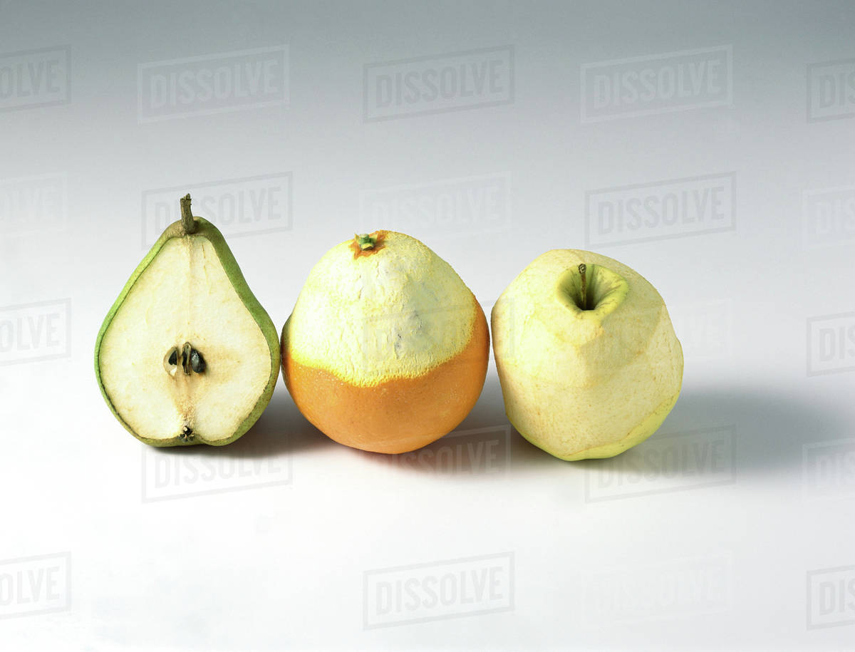 Pear, orange, and apple in a row, all partially peeled - Royalty-free ...
