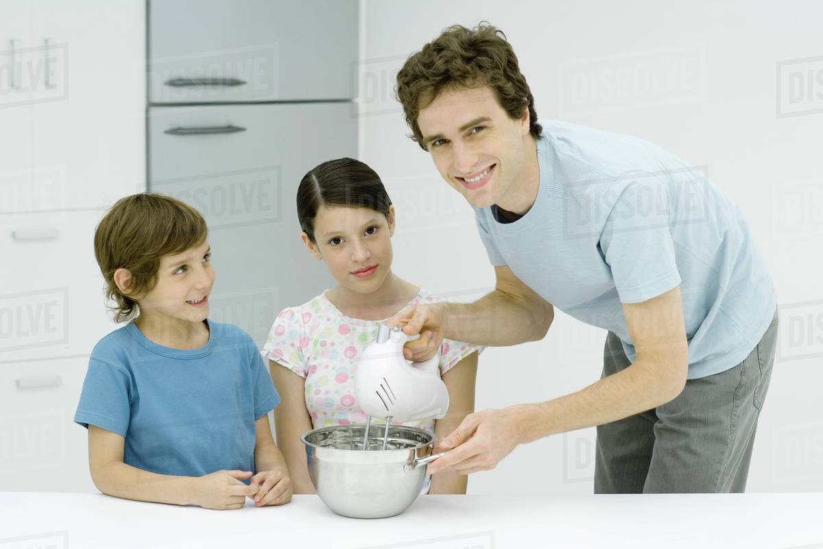 Man cooking with girl and boy, smiling at camera - Royalty-free Stock ...