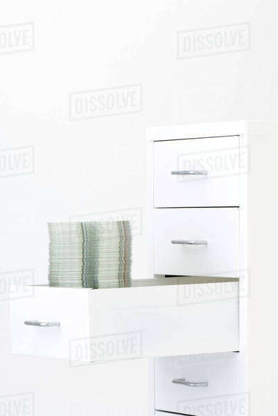 Stack of CDs in filing cabinet drawer - Stock Photo - Dissolve