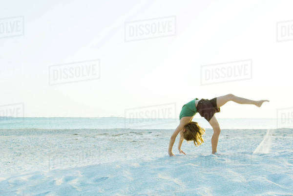 Girl doing gymnastics on beach - Royalty-free Stock Photo | Dissolve