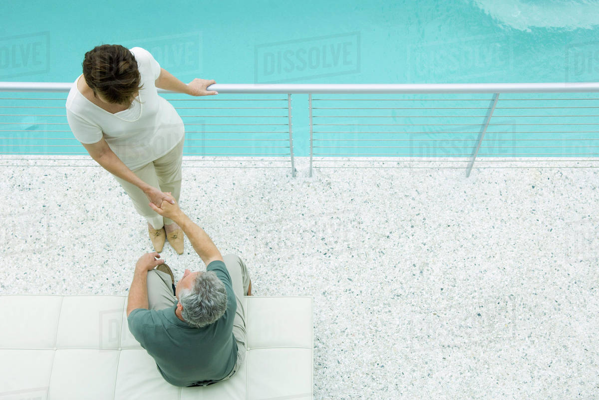 Couple on balcony, holding hands, high angle view - Royalty-free Stock ...