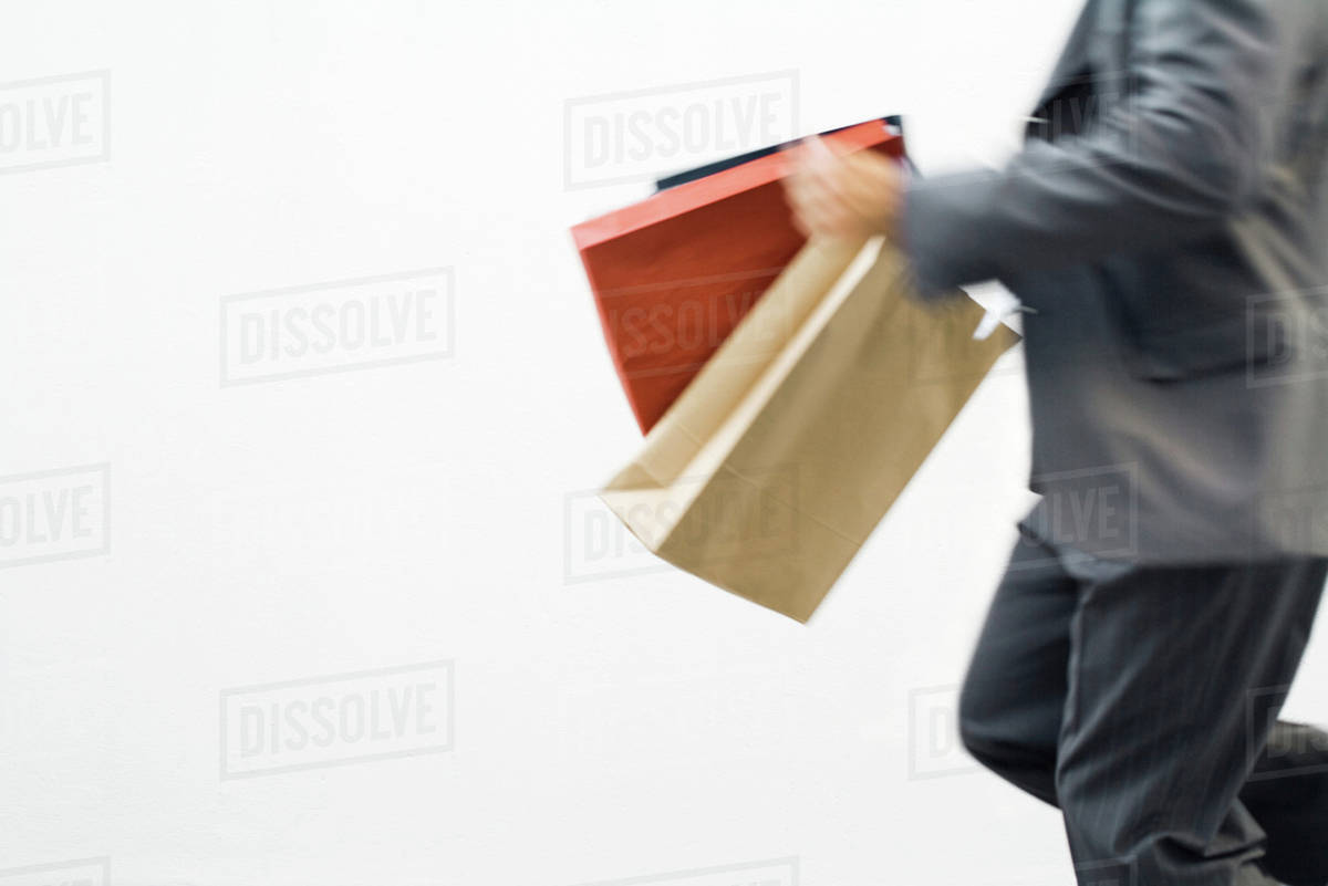 Man running with shopping bags, cropped view - Royalty-free Stock Photo ...