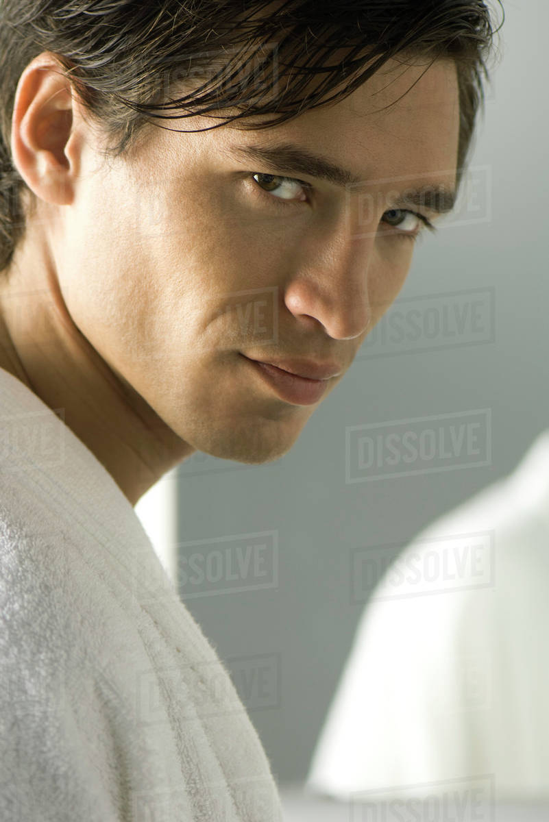 Man looking over shoulder, smirking at camera - Royalty-free Stock ...