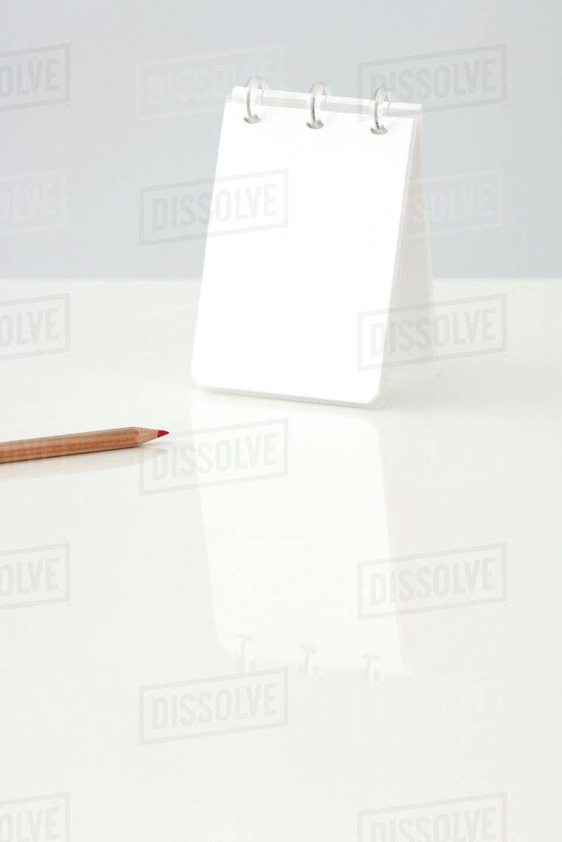Notepad upright on table, cropped view of pencil nearby - Royalty-free ...