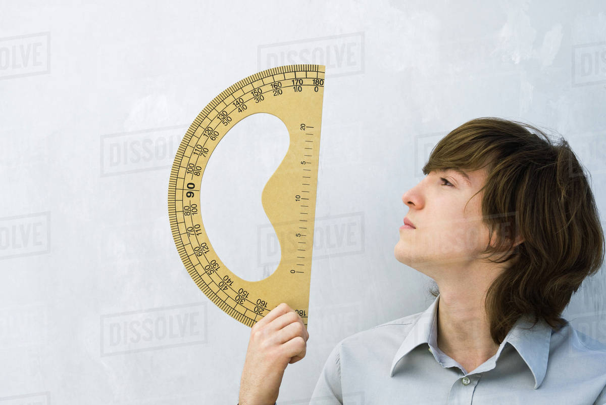 Young man holding up protractor, profile - Royalty-free Stock Photo ...
