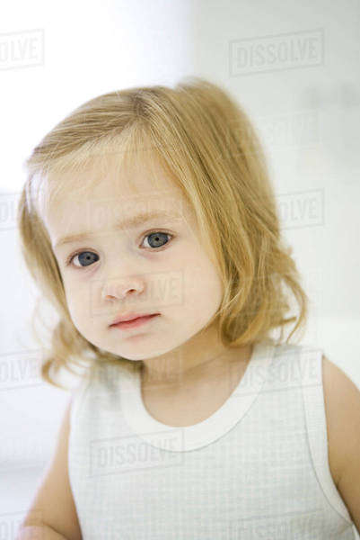 Toddler girl looking at camera, portrait - Stock Photo - Dissolve