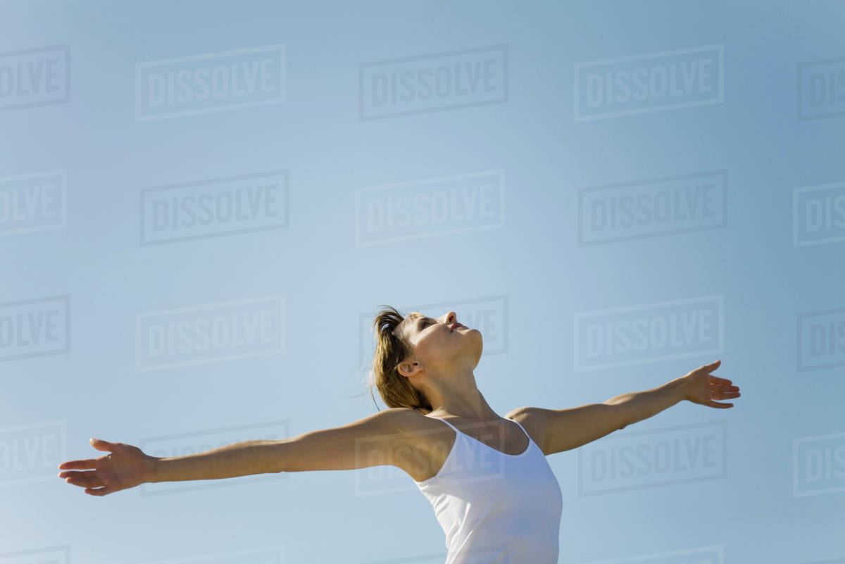 Woman standing outdoors with arms out, head back - Royalty-free Stock ...