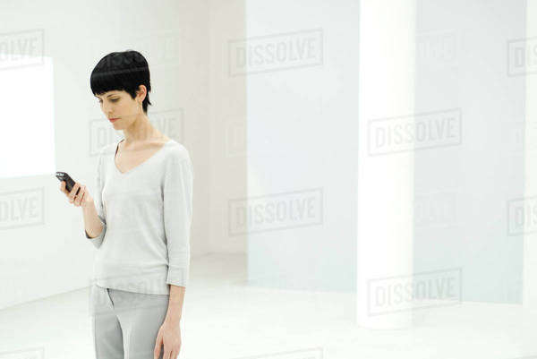 Professional woman looking at cell phone - Royalty-free Stock Photo ...