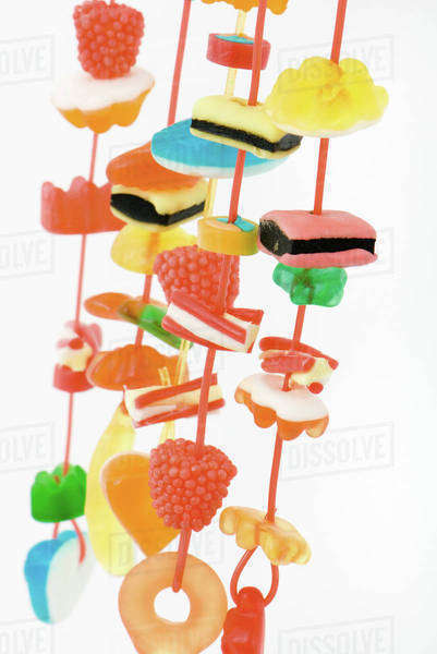 Colorful candy hanging on strings - Royalty-free Stock Photo | Dissolve