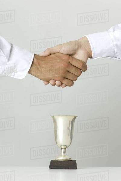 Shaking hands over trophy, cropped view - Royalty-free Stock Photo ...