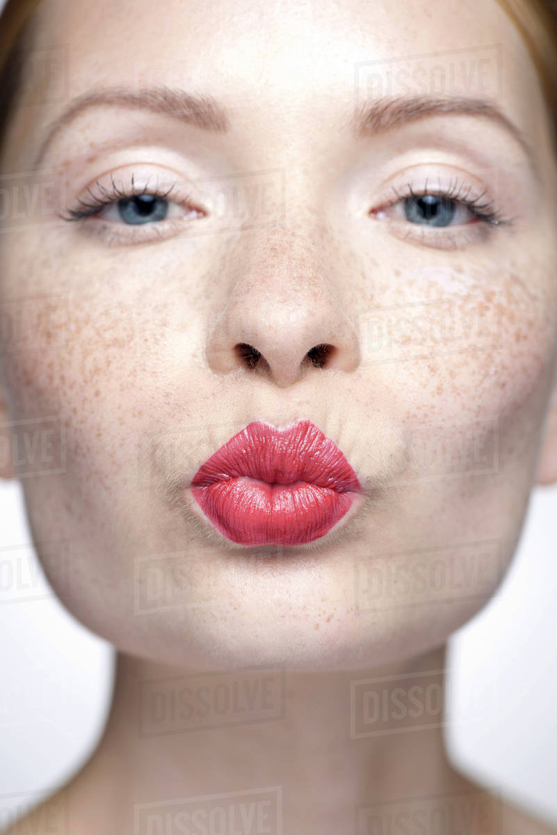 Young woman with pursed lips wearing red lipstick, close-up - Royalty ...