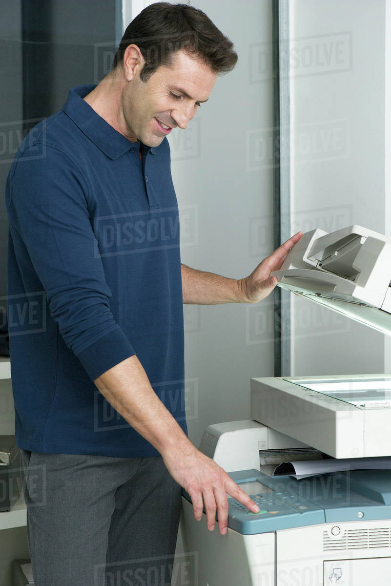 Man using photocopier - Royalty-free Stock Photo | Dissolve