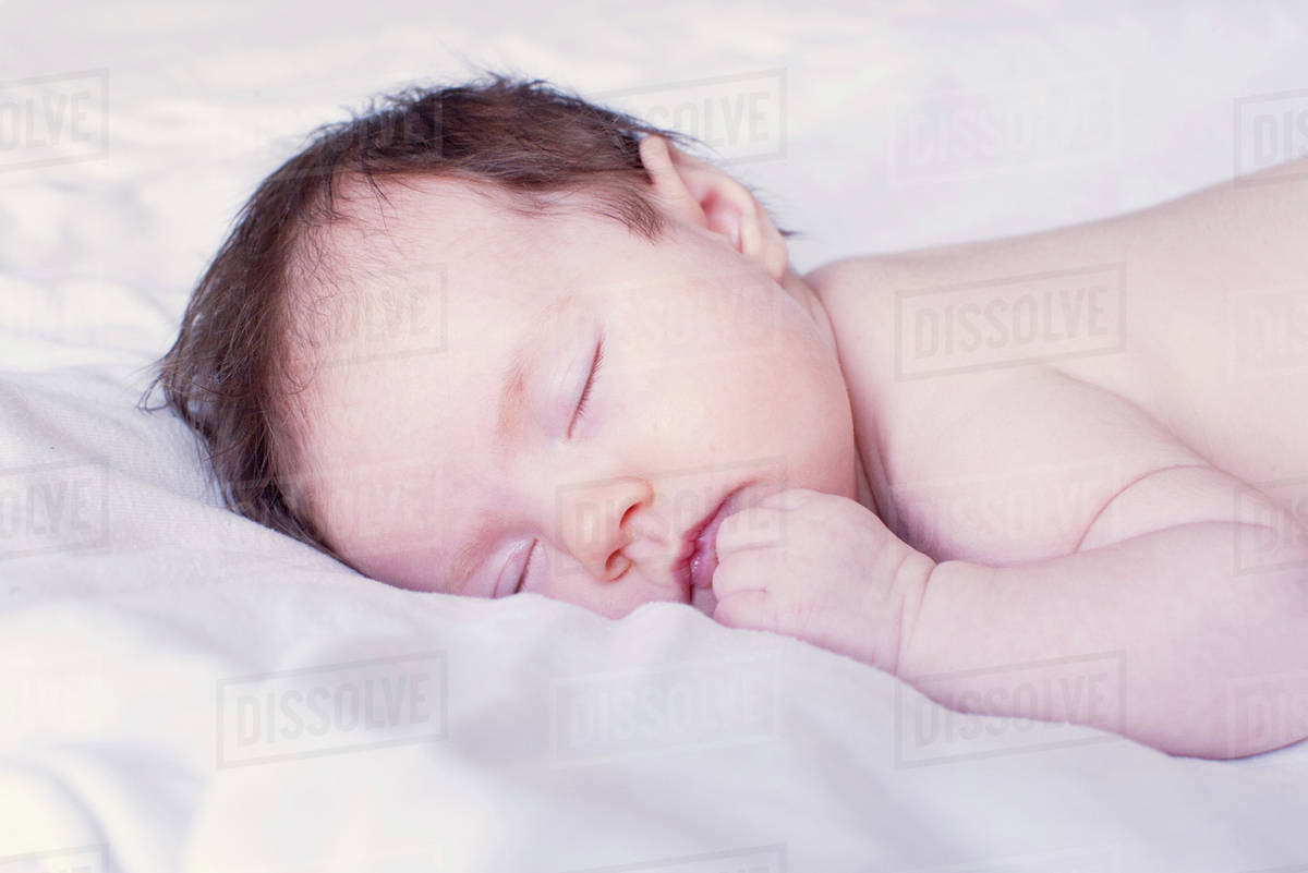 Baby napping in bed - Royalty-free Stock Photo | Dissolve