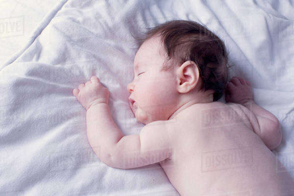 Baby napping in bed - Royalty-free Stock Photo | Dissolve