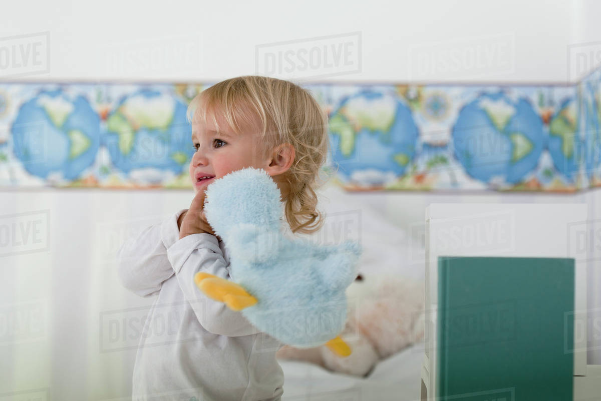 Baby boy carrying stuffed toy on shoulder - Royalty-free Stock Photo ...