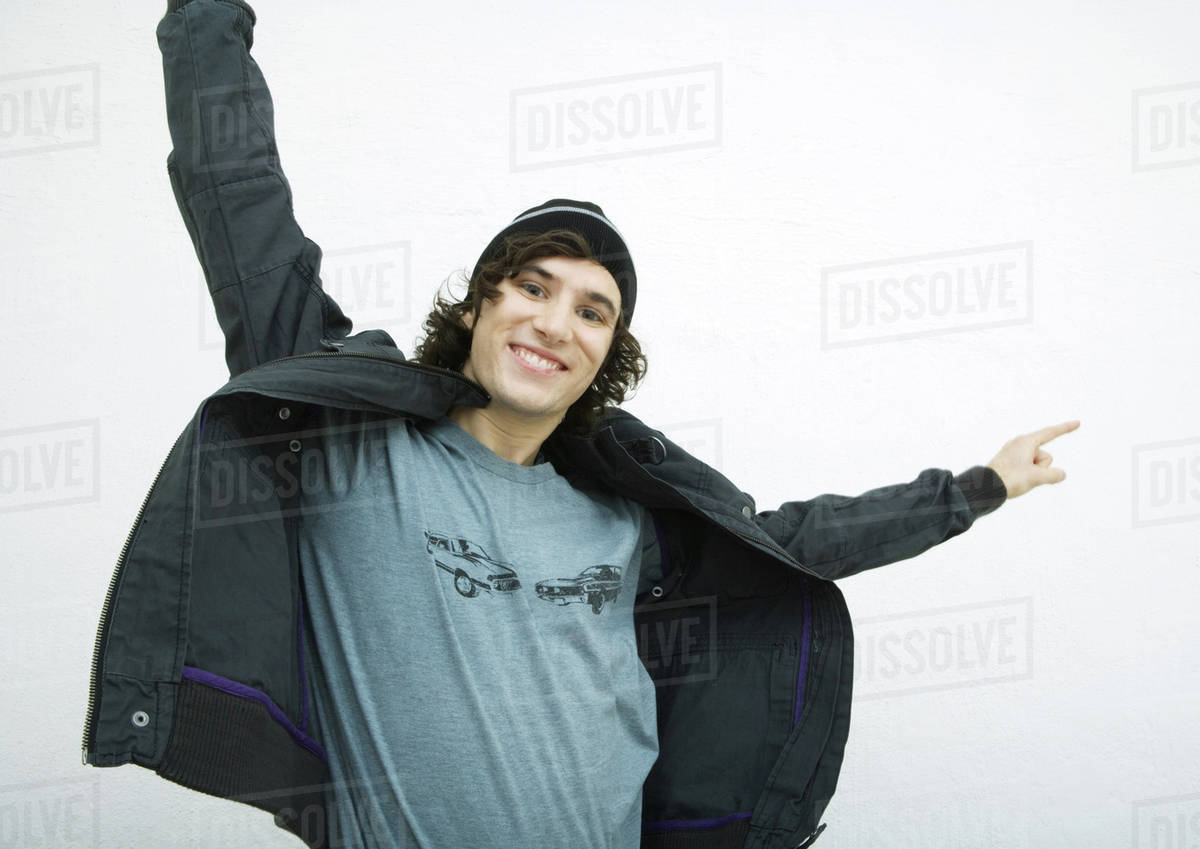 Young man with arms out, smiling at camera, portrait - Royalty-free ...