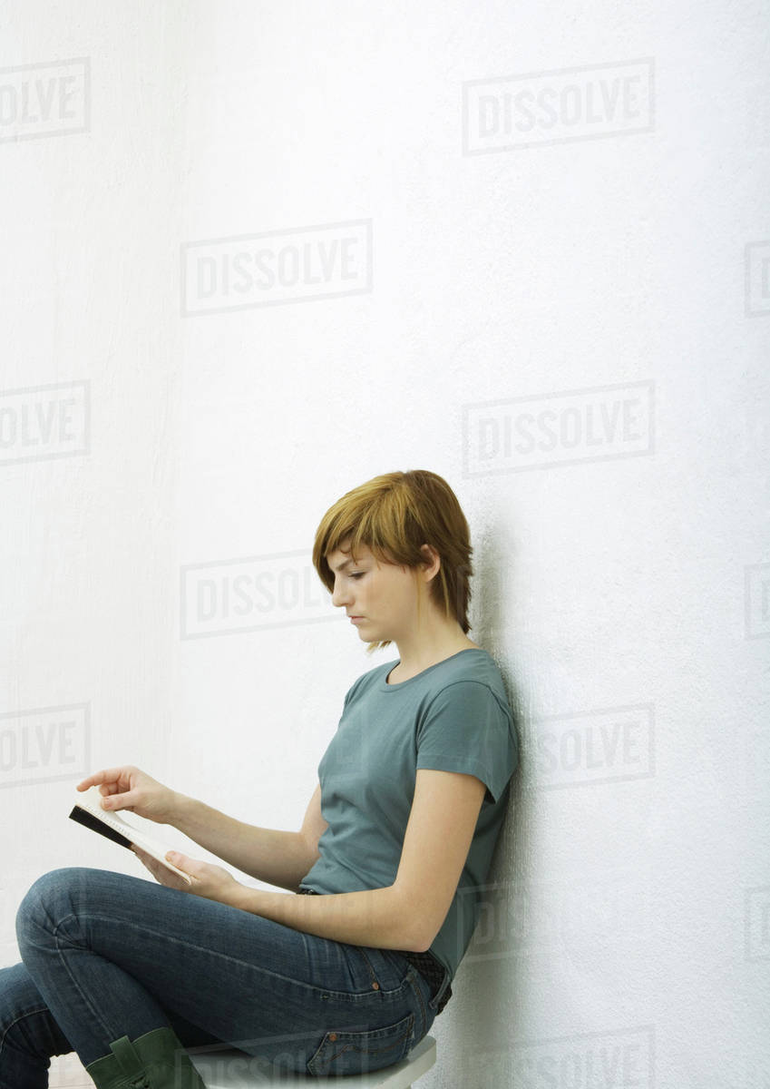 Young woman reading book, white background - Stock Photo - Dissolve