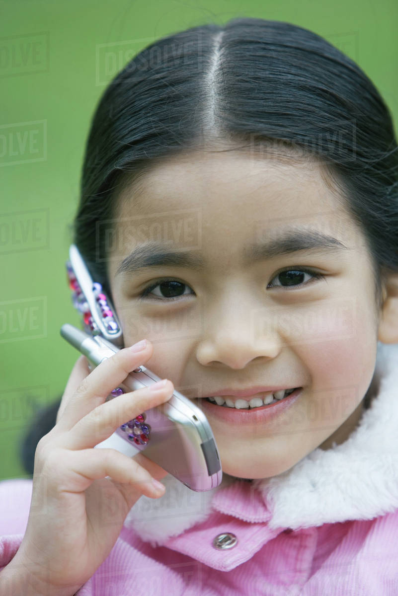 Little girl using cell phone, close-up - Stock Photo - Dissolve