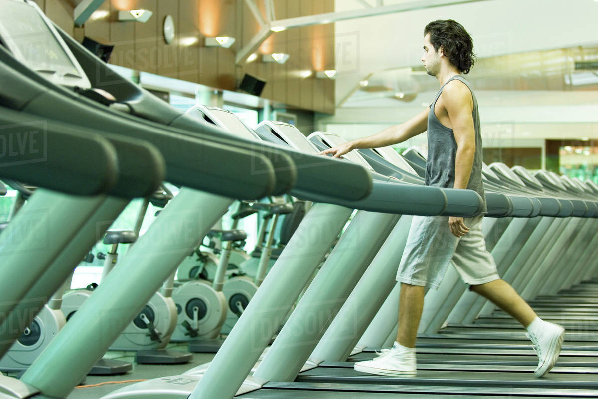 Man running on treadmill - Stock Photo - Dissolve