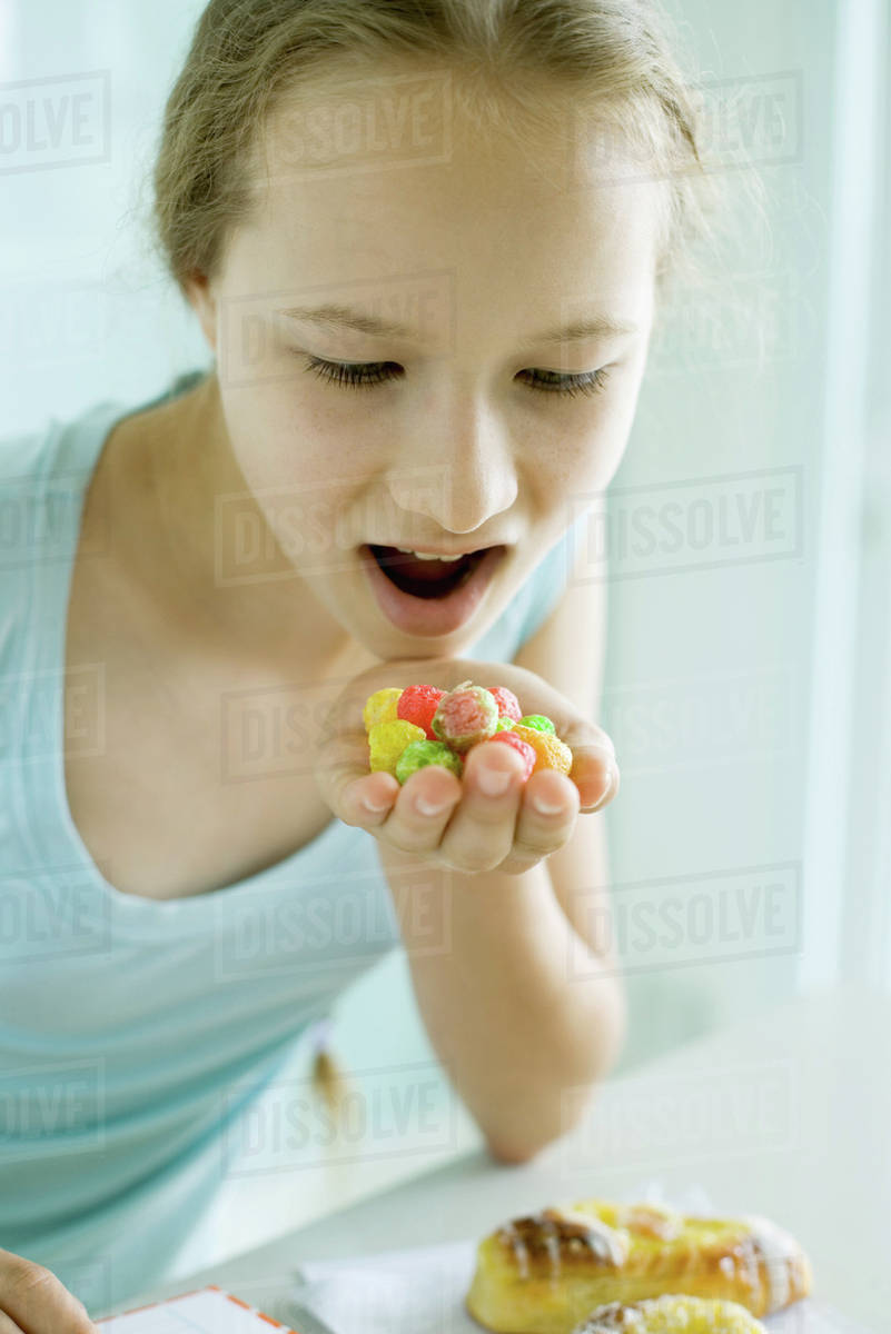 Girl eating sweets - Royalty-free Stock Photo | Dissolve