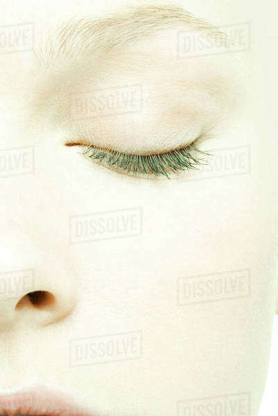 Teenage girl's face, eye closed, extreme close-up - Stock Photo - Dissolve